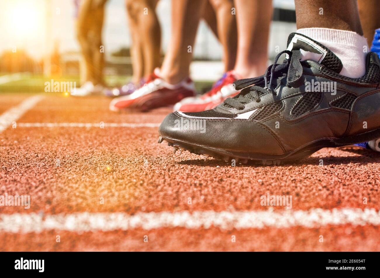 Group of female track athletes on starting blocks Stock Photo - Alamy