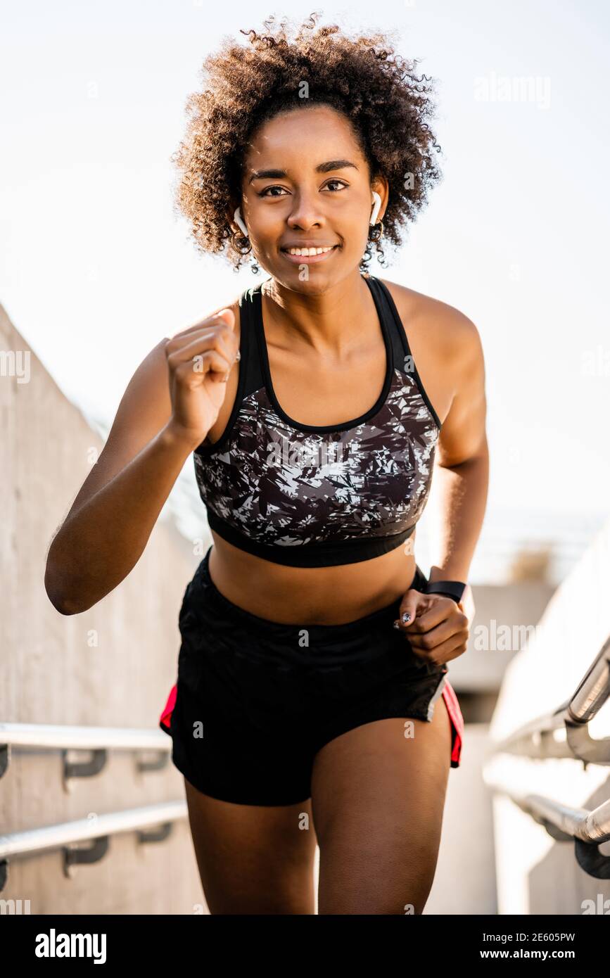 Afro athlete woman running outdoors Stock Photo - Alamy