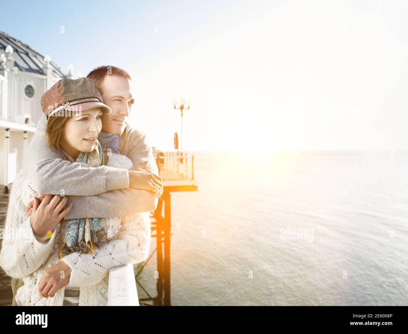 Young couple stand embracing by the sea hi-res stock photography and ...