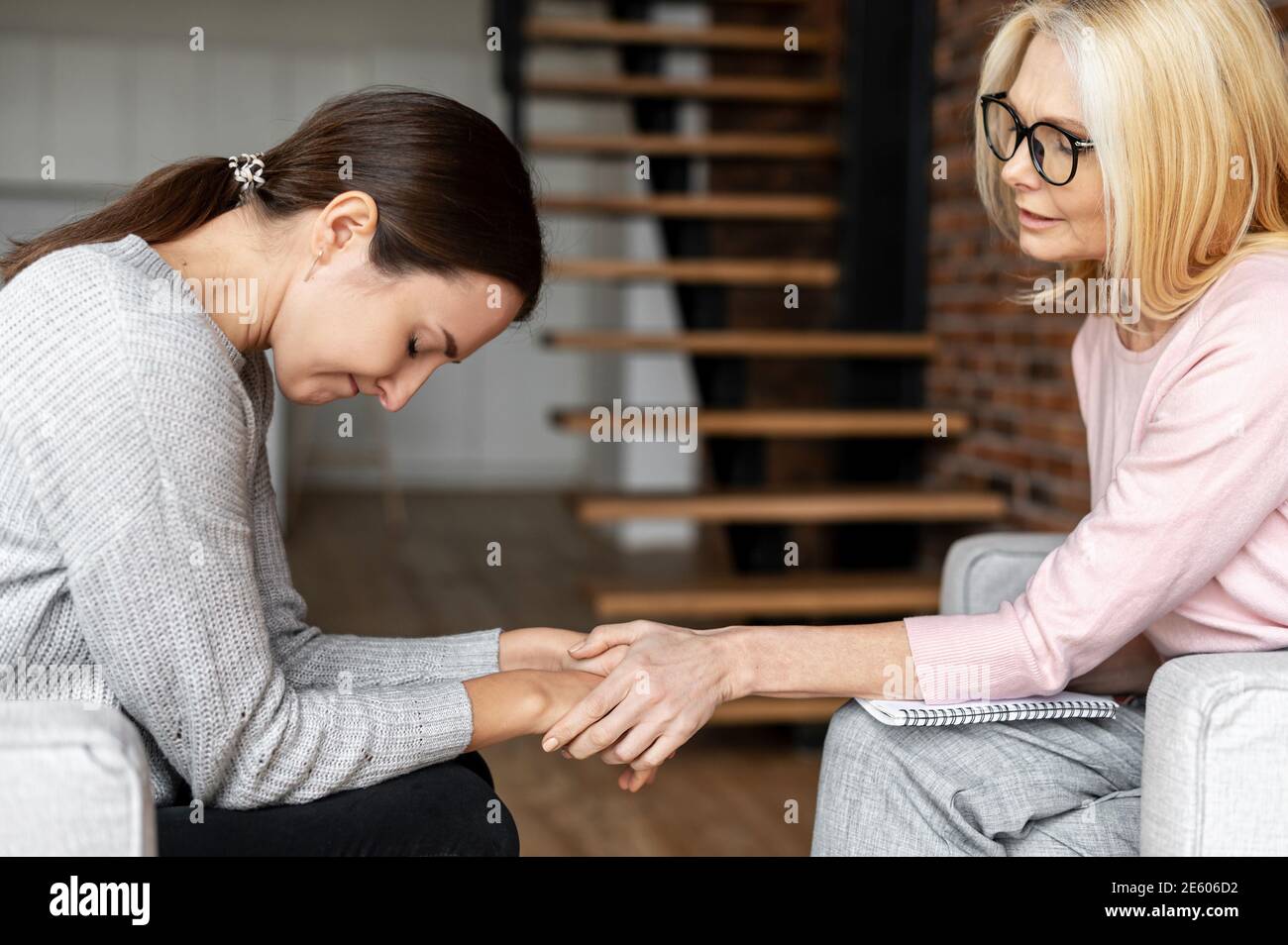 The therapist expresses support and empathy to a upset female patient ...