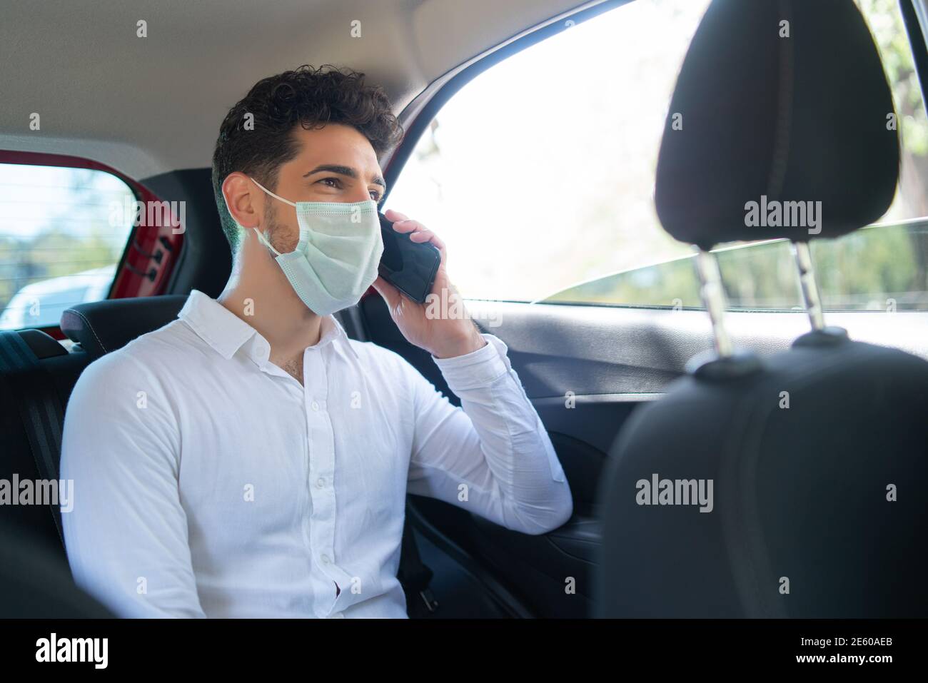 Businessman talking on phone in car Stock Photo - Alamy