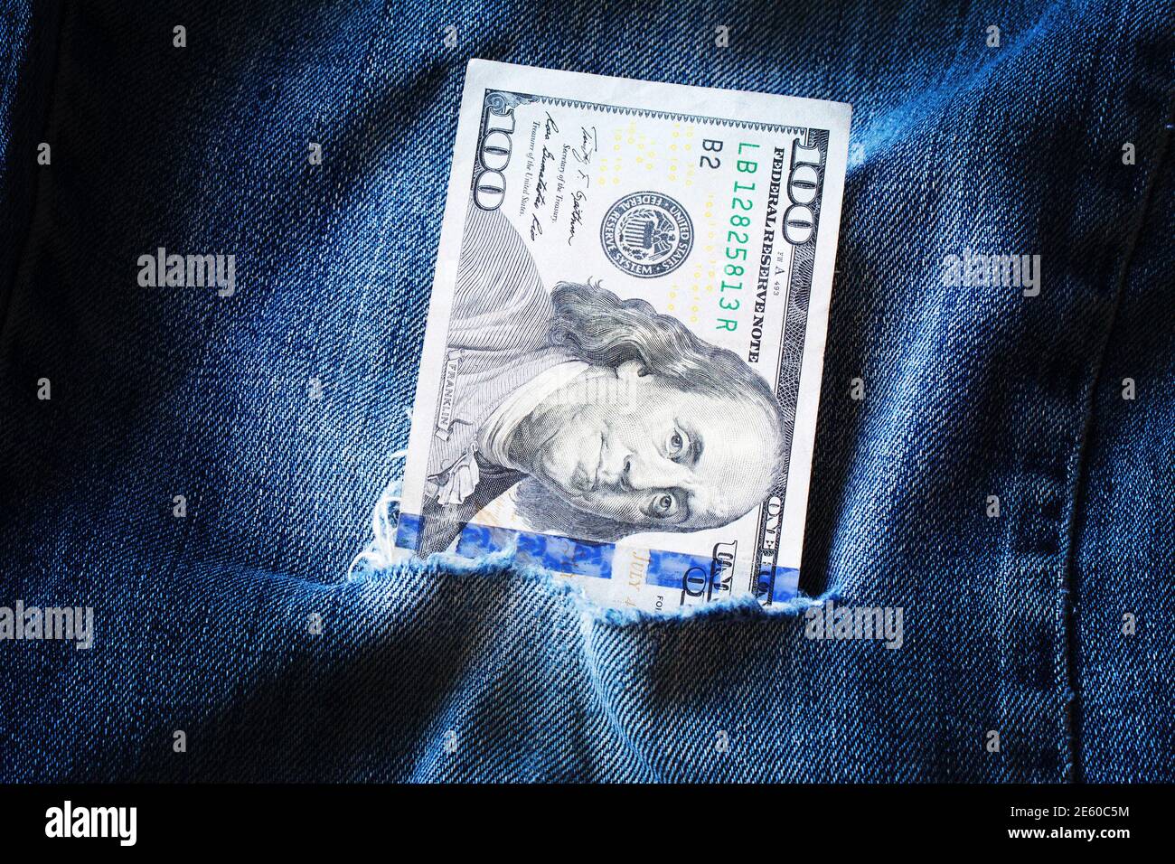 One hundred dollars in ripped blue jeans. Poverty and wealth in torn ...