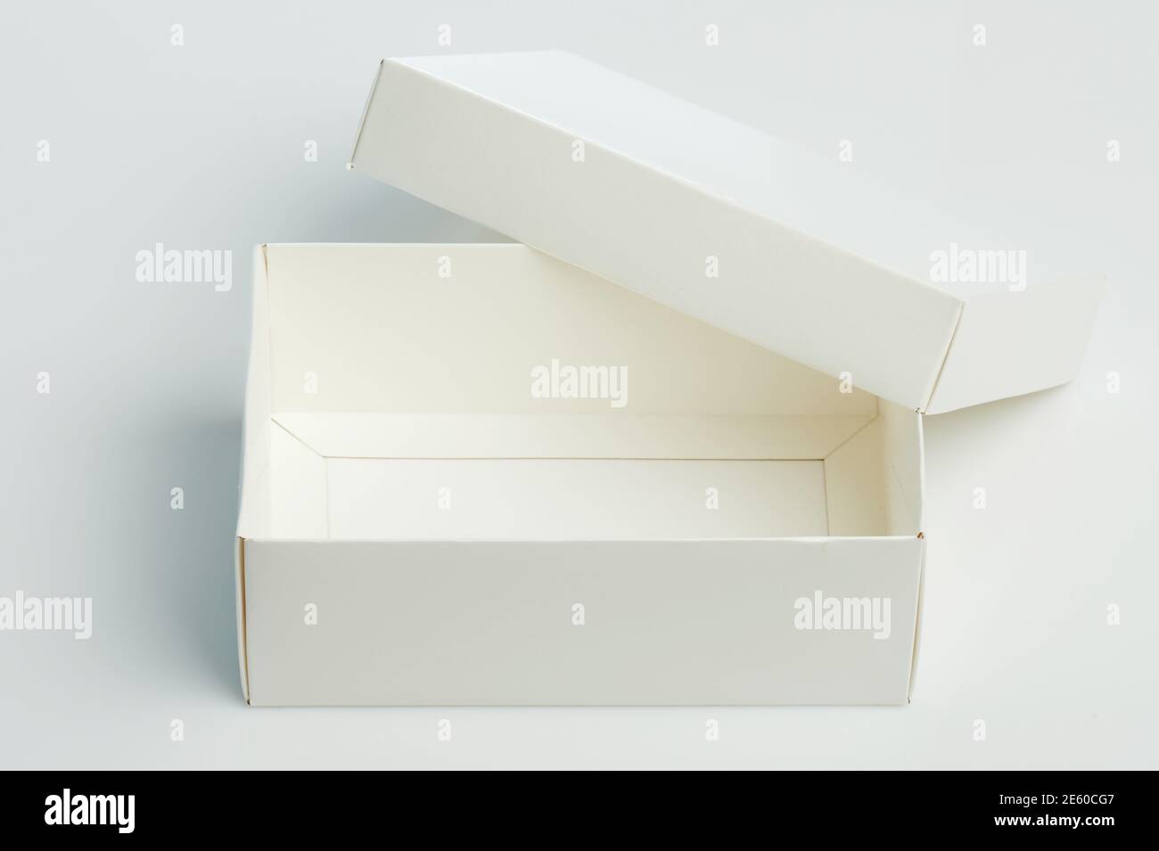 Square white paper box isolated on studio background Stock Photo - Alamy