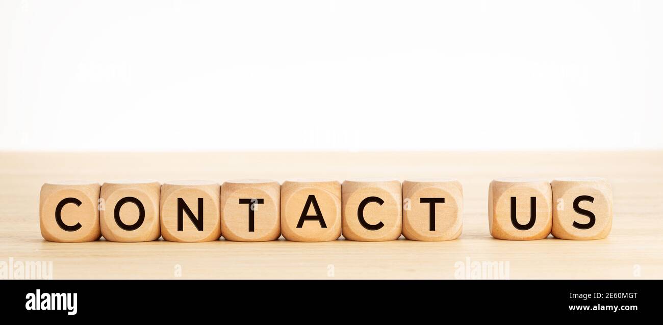 Contact us word on wooden blocks on wood table. Copy space. White ...