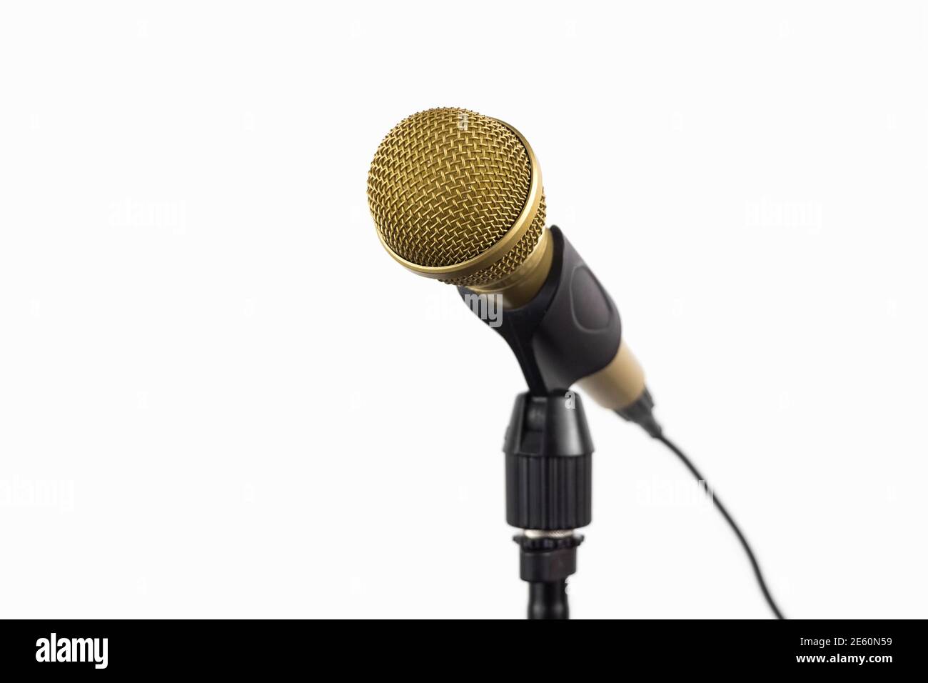 Golden microphone on a stand on white background Stock Photo - Alamy
