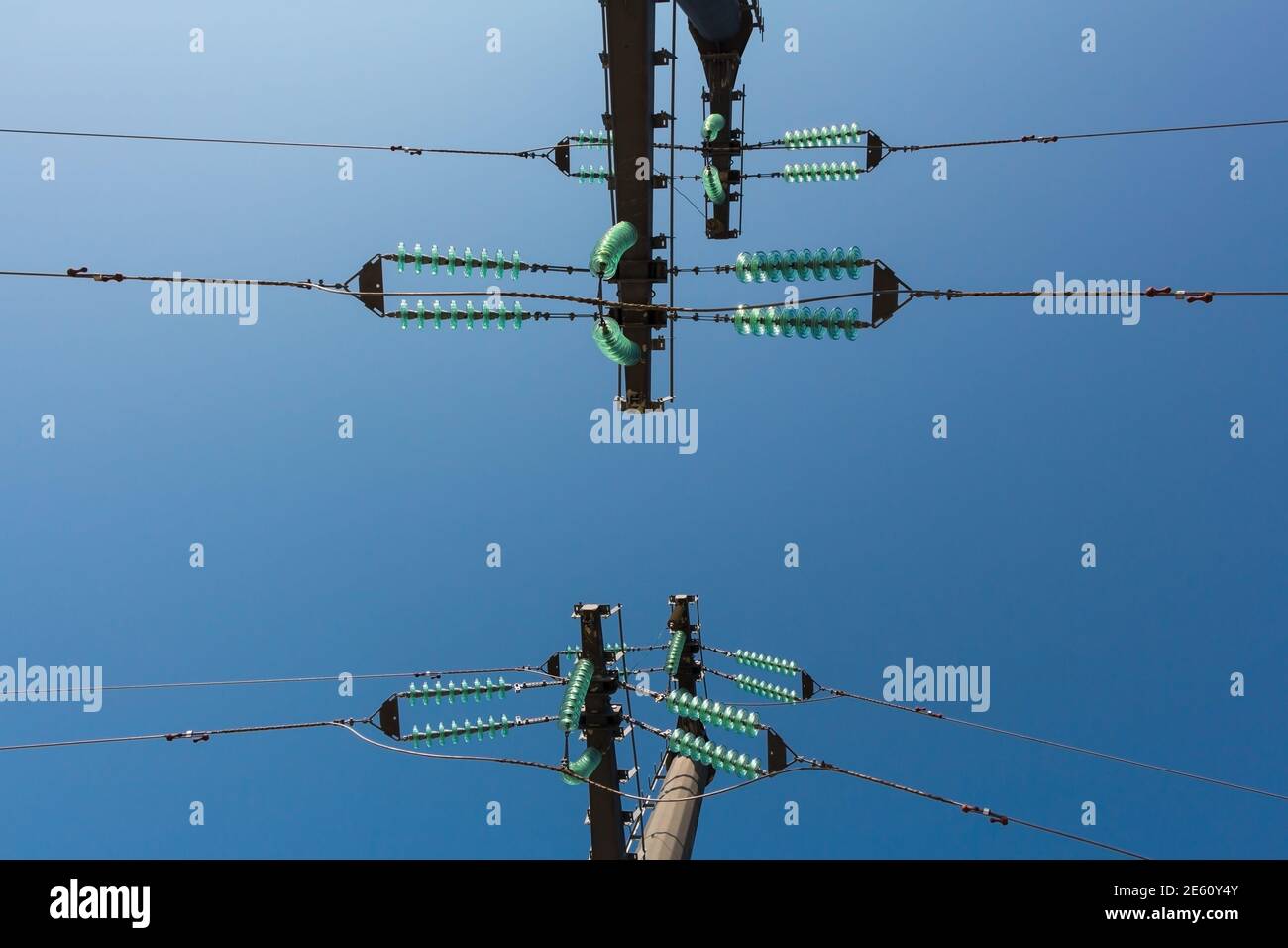 High voltage power lines on deep blue sky, bottom view Stock Photo - Alamy