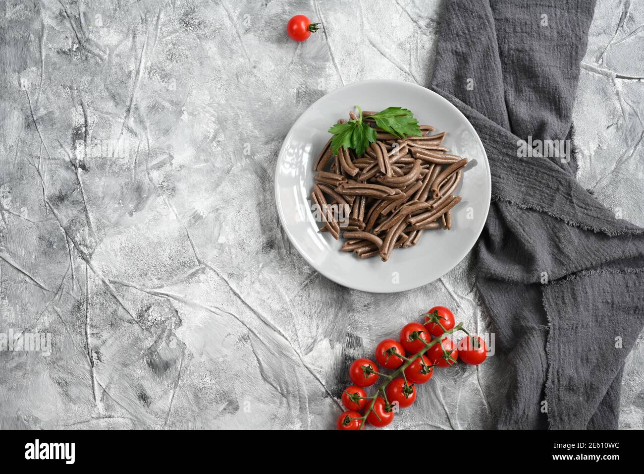 buckwheat spaghetti. Buckwheat pasta on a light grey table. Asian soba ...