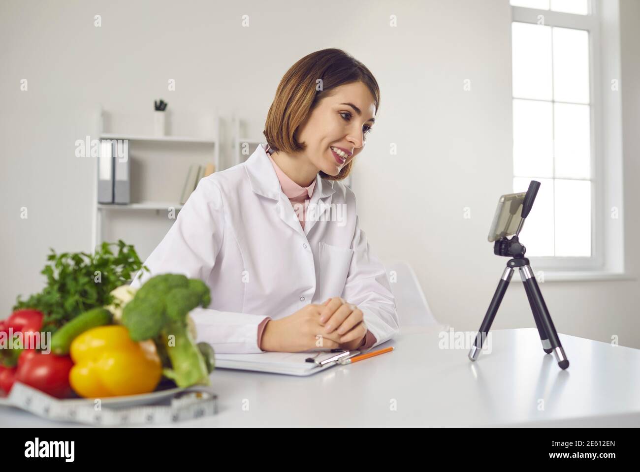 Nutritionist at the clinic video calling patient for online ...