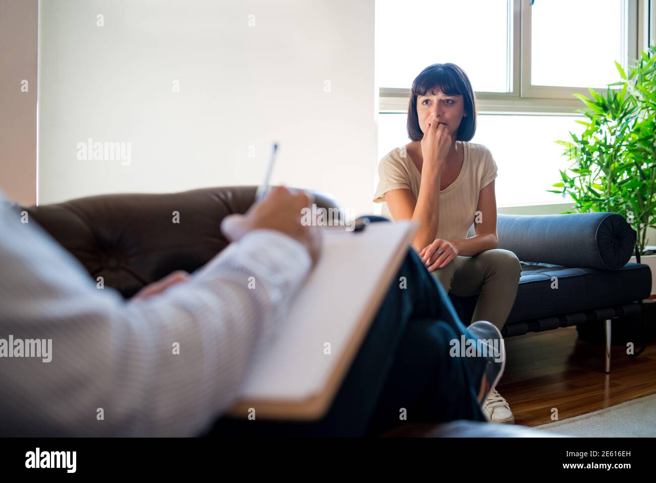 Psychologist taking notes during therapy session Stock Photo - Alamy