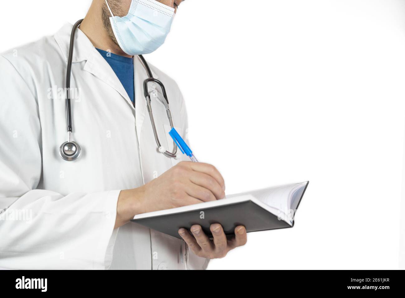 Male doctor taking notes isolated on a white background Stock Photo - Alamy