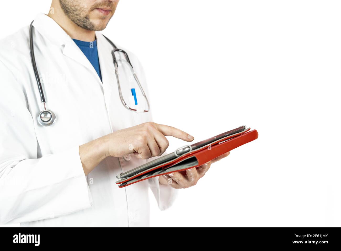 Male doctor taking notes on a tablet isolated on a white background ...
