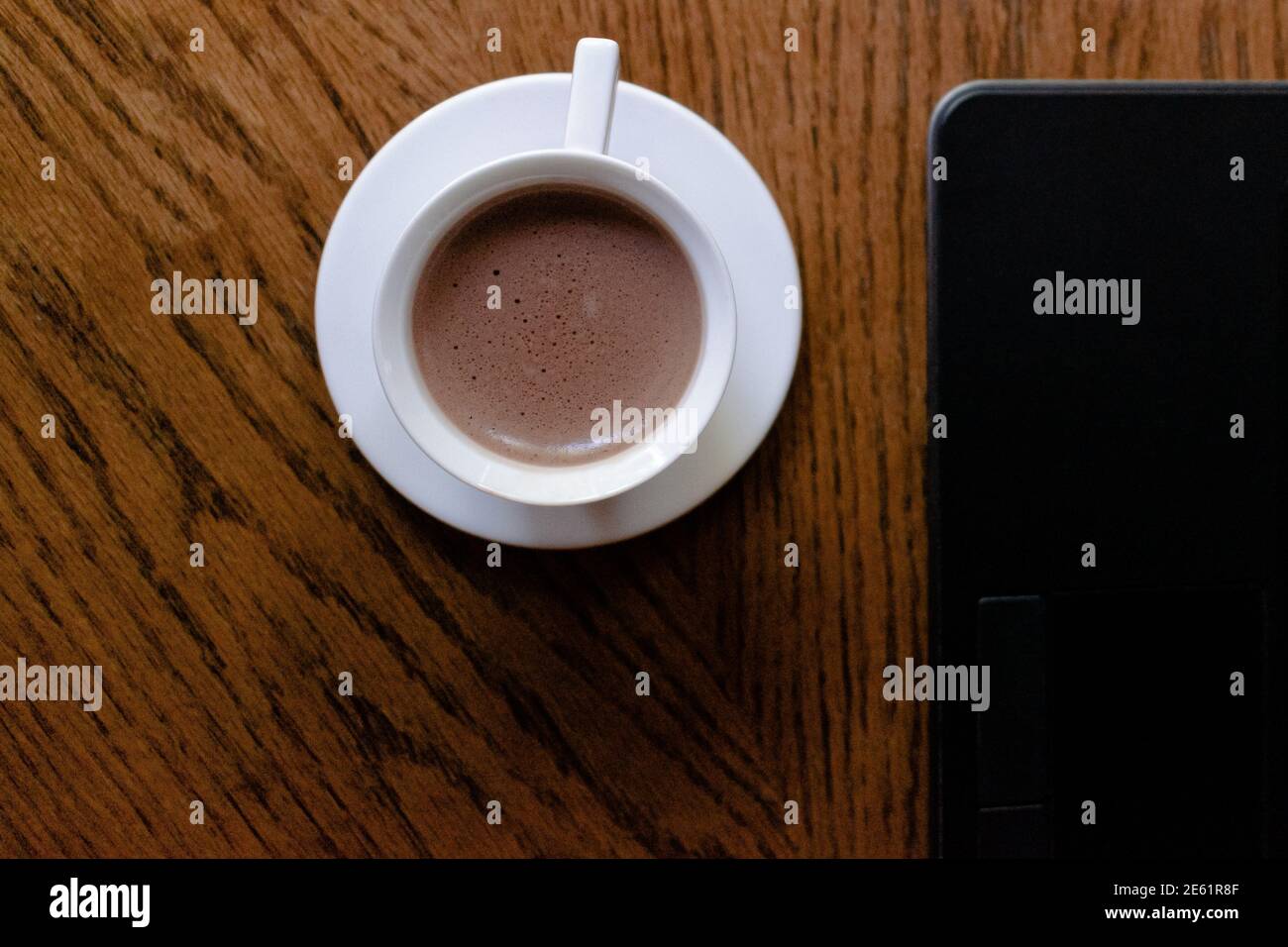 Delicious hot chocolate in brown table and one computer accompanying ...