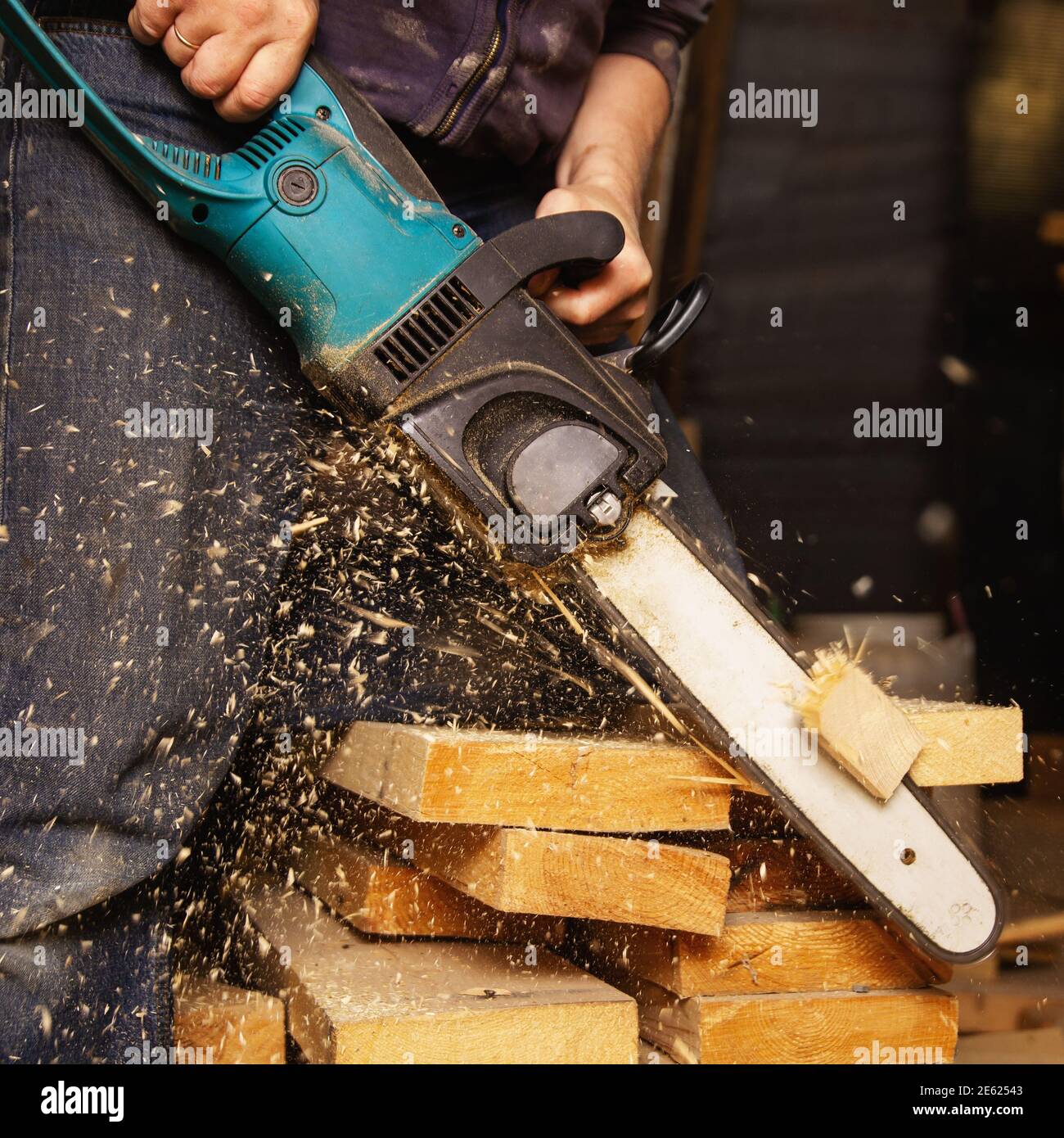 Construction of a house, a man works with a circular electric saw and ...