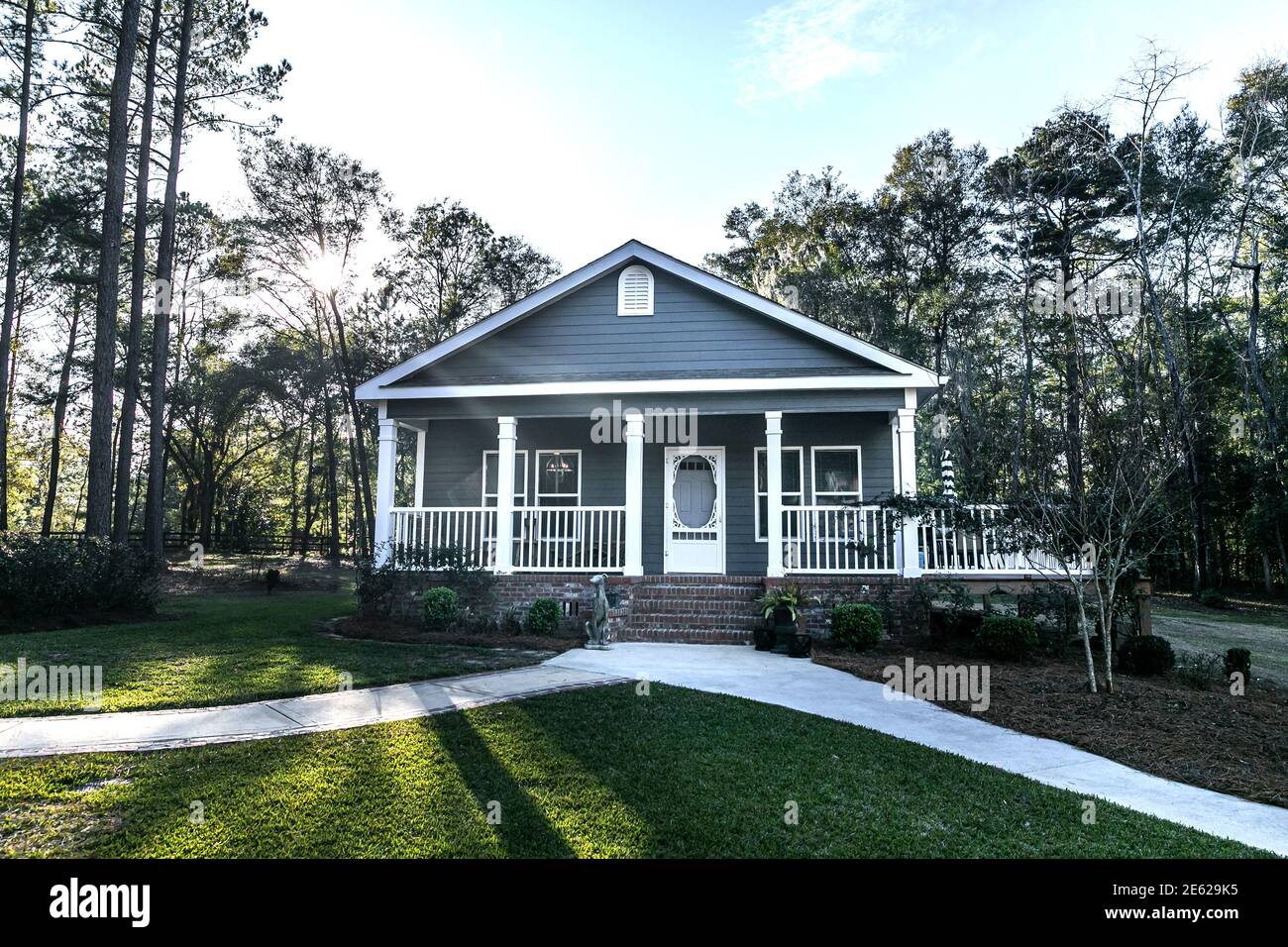Small blue gray mobile home with a front and side porch with white ...