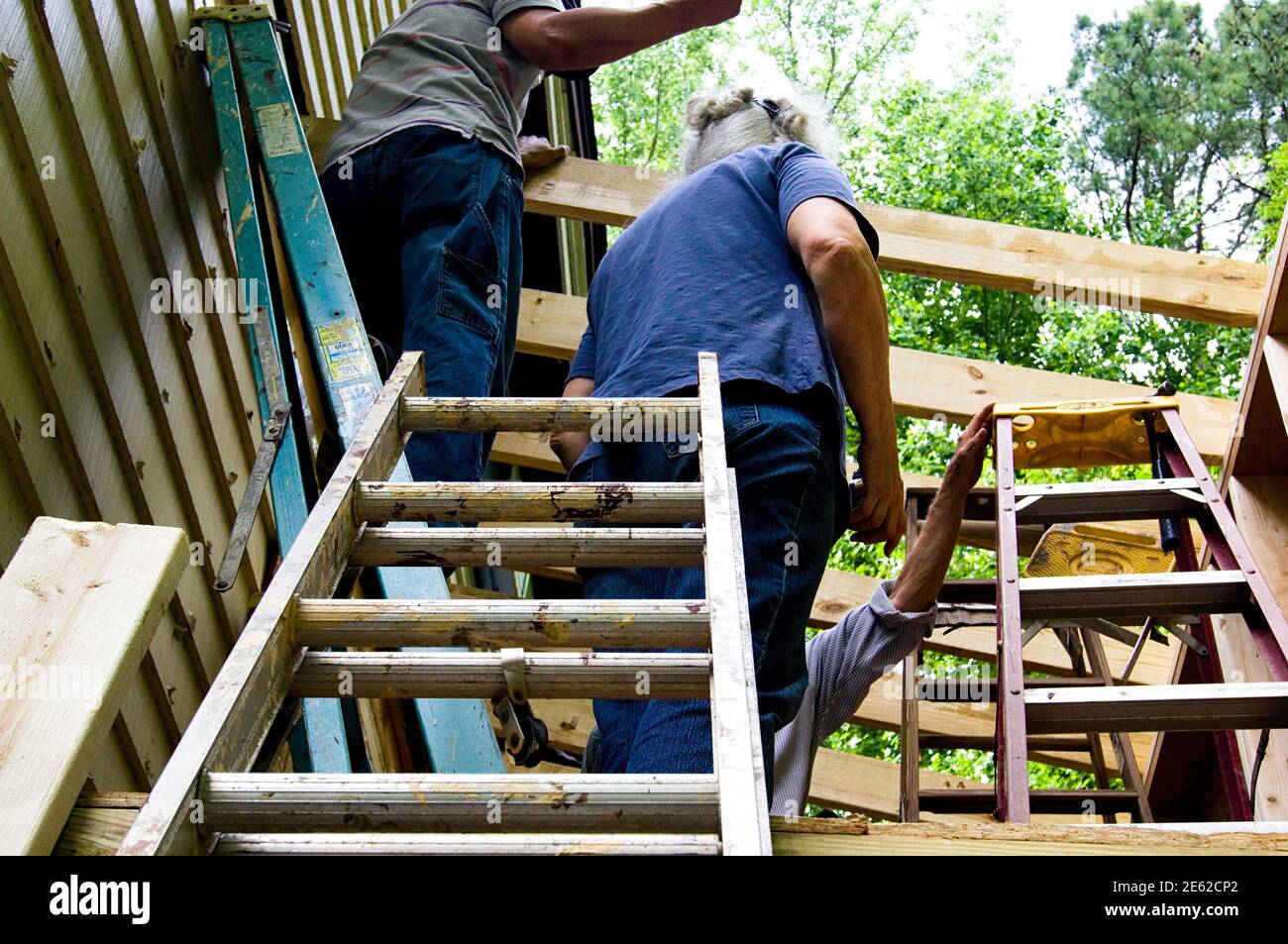 Three people doing construction work at home Stock Photo - Alamy