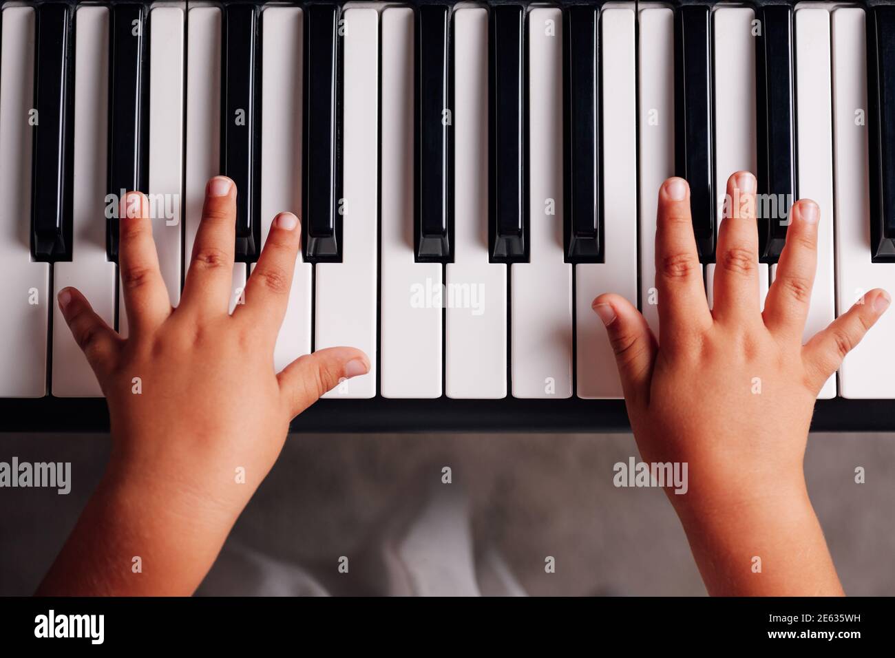 Top view, close-up on two children's hands with fingers spread out as ...