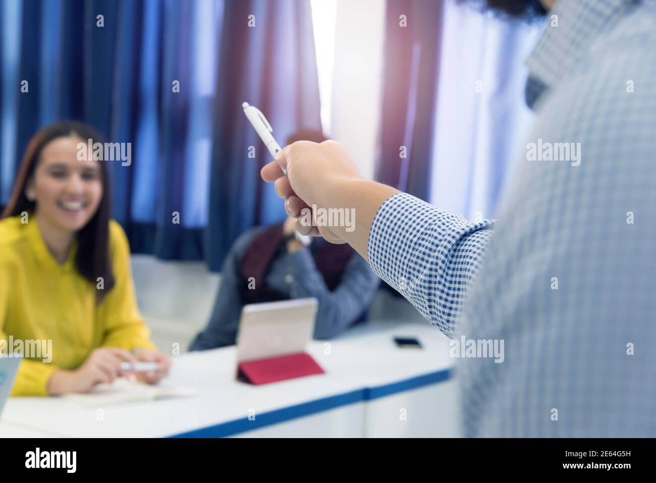 University students in the classroom with a teacher explaining them ...