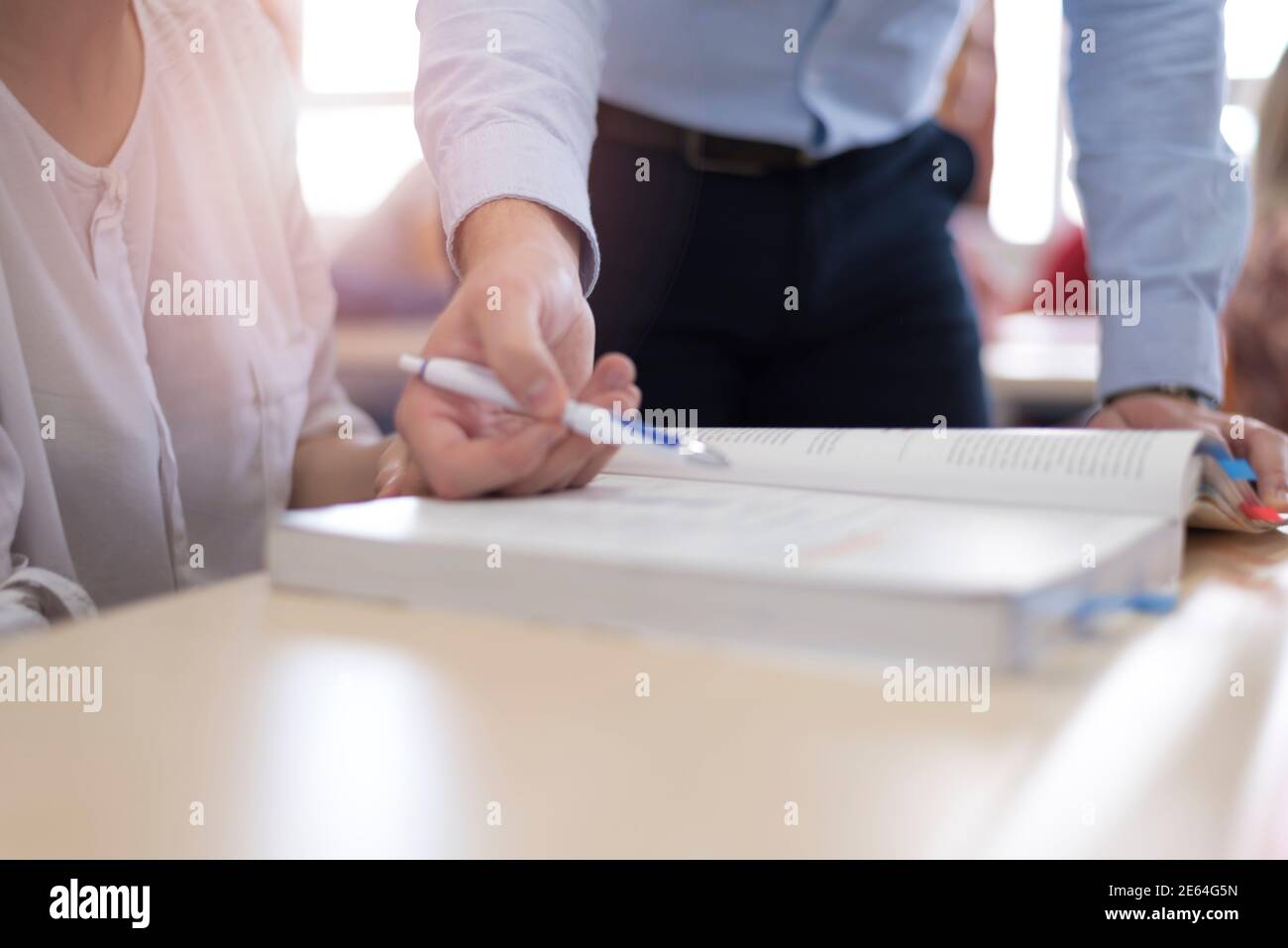 University students in the classroom with a teacher explaining them ...