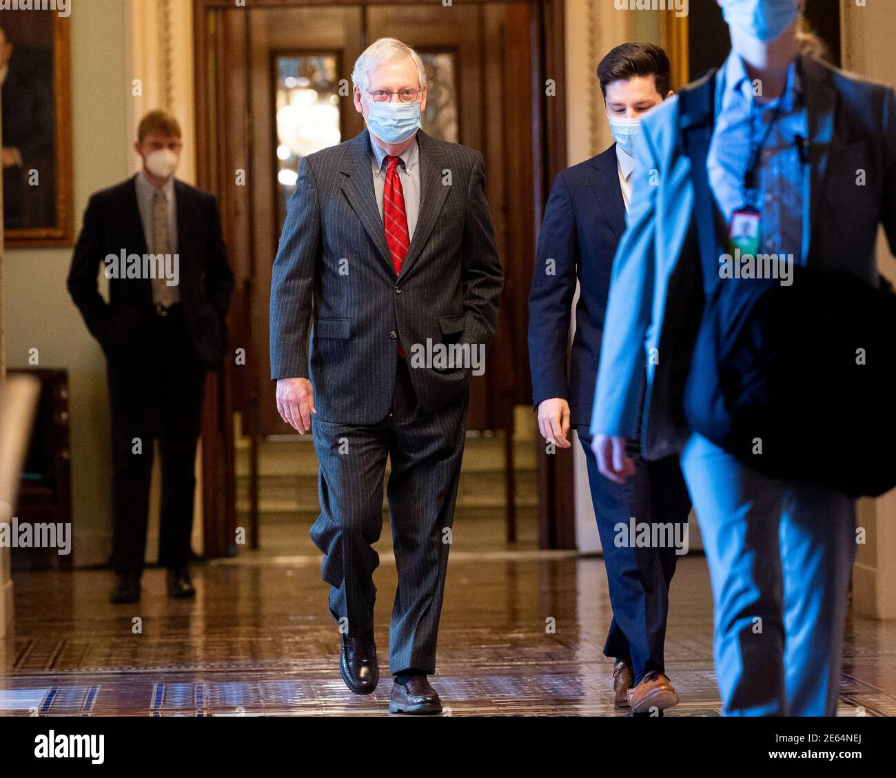 Senate Minority Leader Mitch McConnell (R-KY) wearing a face mask walks ...