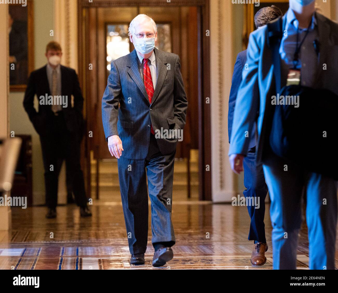 Senate Minority Leader Mitch McConnell (R-KY) wearing a face mask walks ...