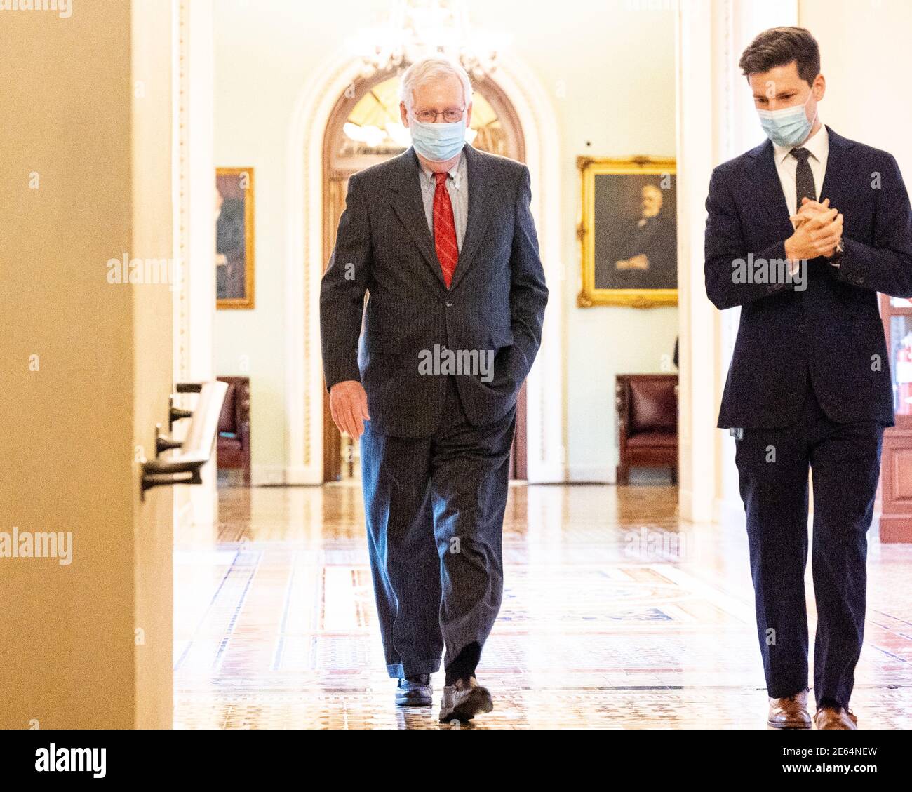 Senate Minority Leader Mitch McConnell (R-KY) wearing a face mask walks ...