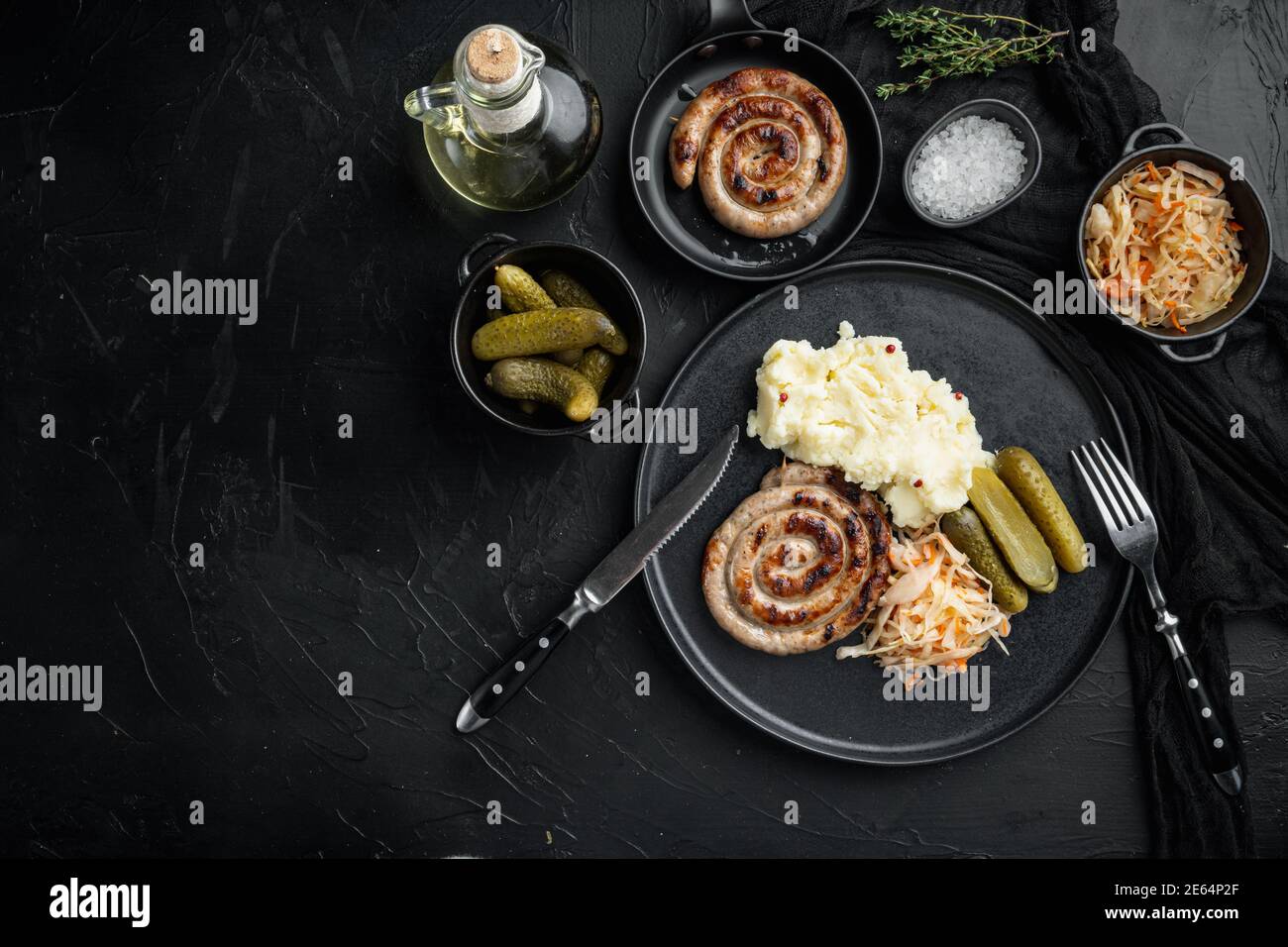 Bavarian fried sausage on sauerkraut, on black background, top view ...