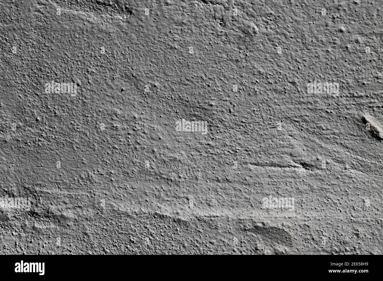 Exterior wall of a building with rough texture and painted white with ...