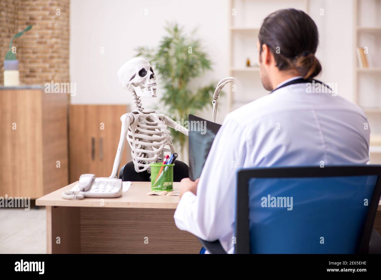 Young doctor radiologist and skeleton patient in the clinic Stock Photo ...