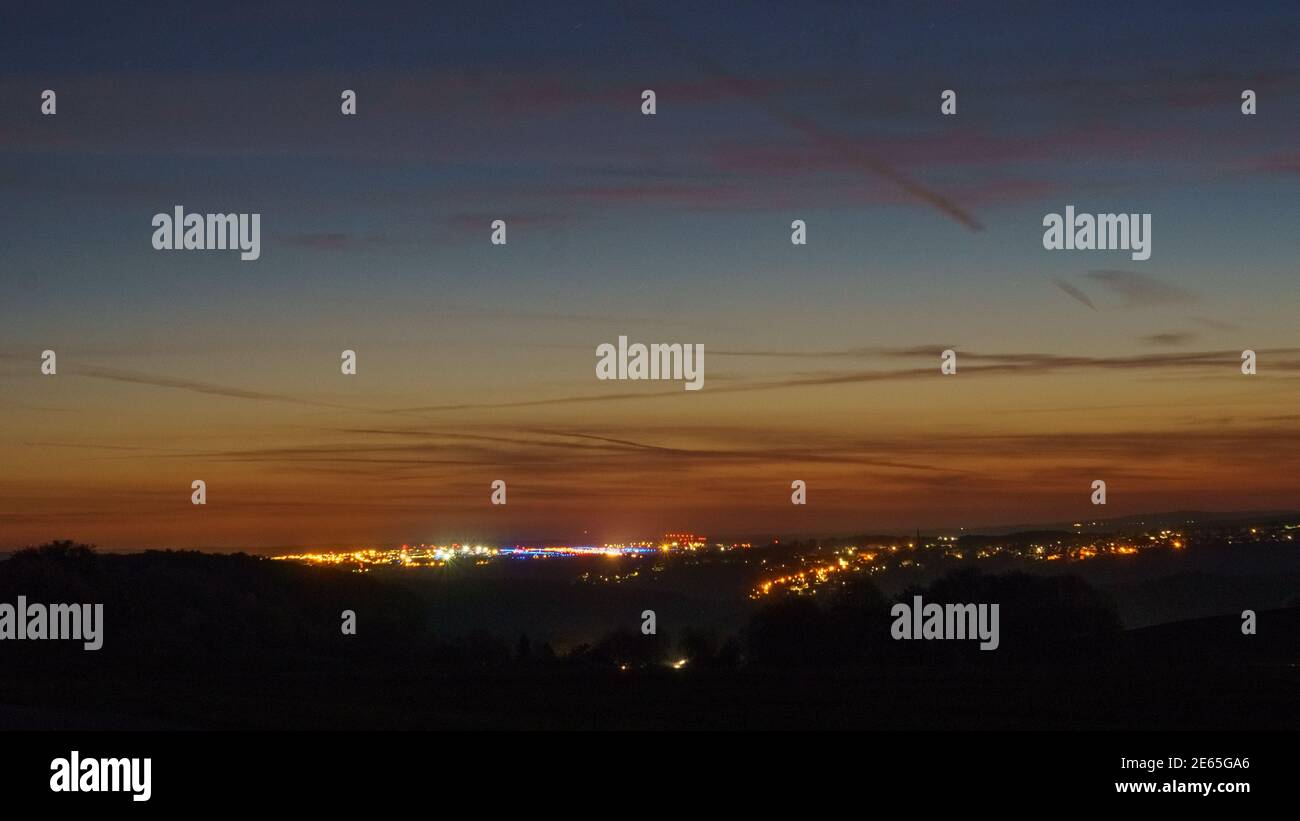 Early morning dawn with colorful sky over lights of spangdahlem air ...