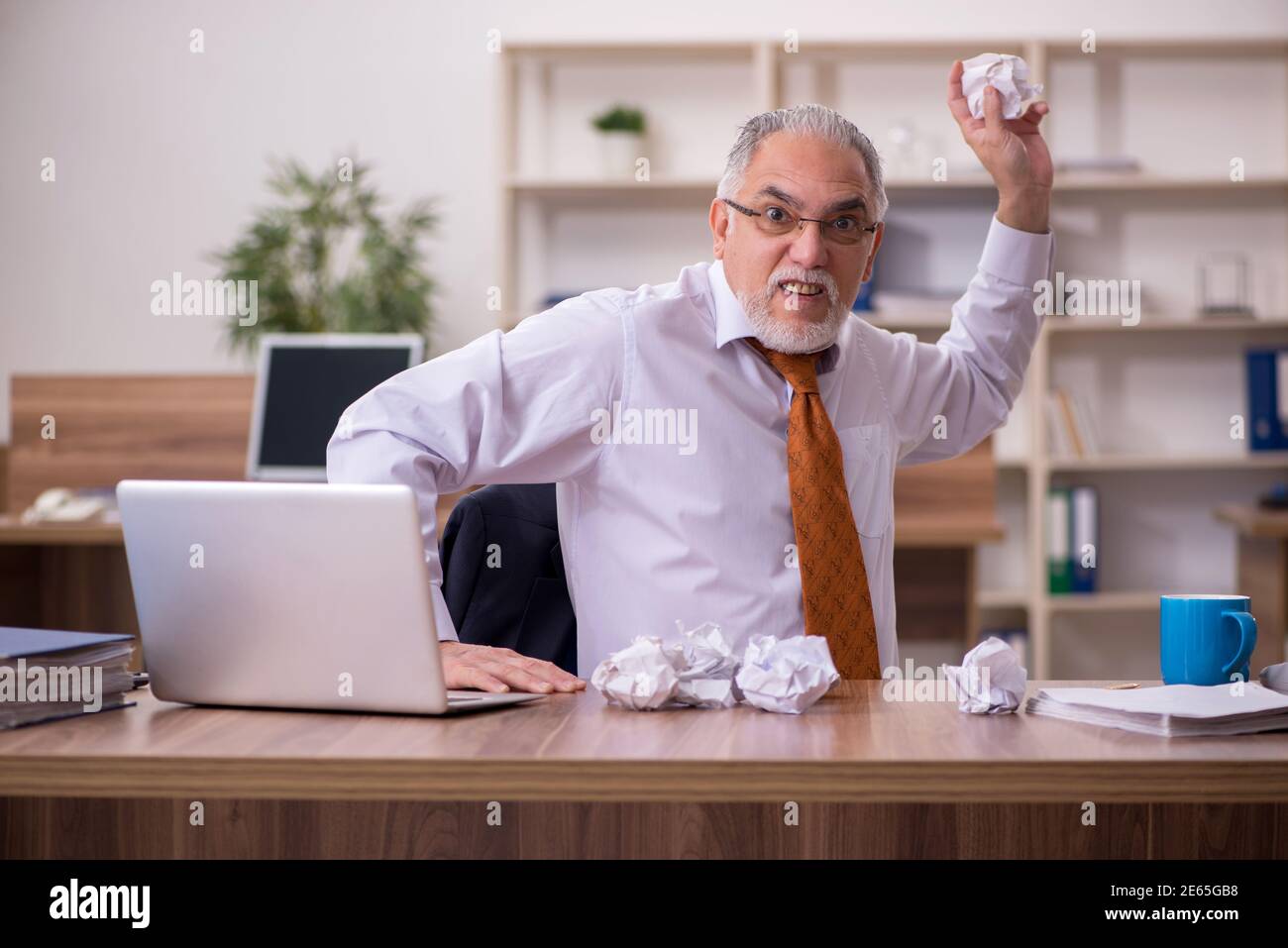 Old employee in paper recycling concept Stock Photo - Alamy