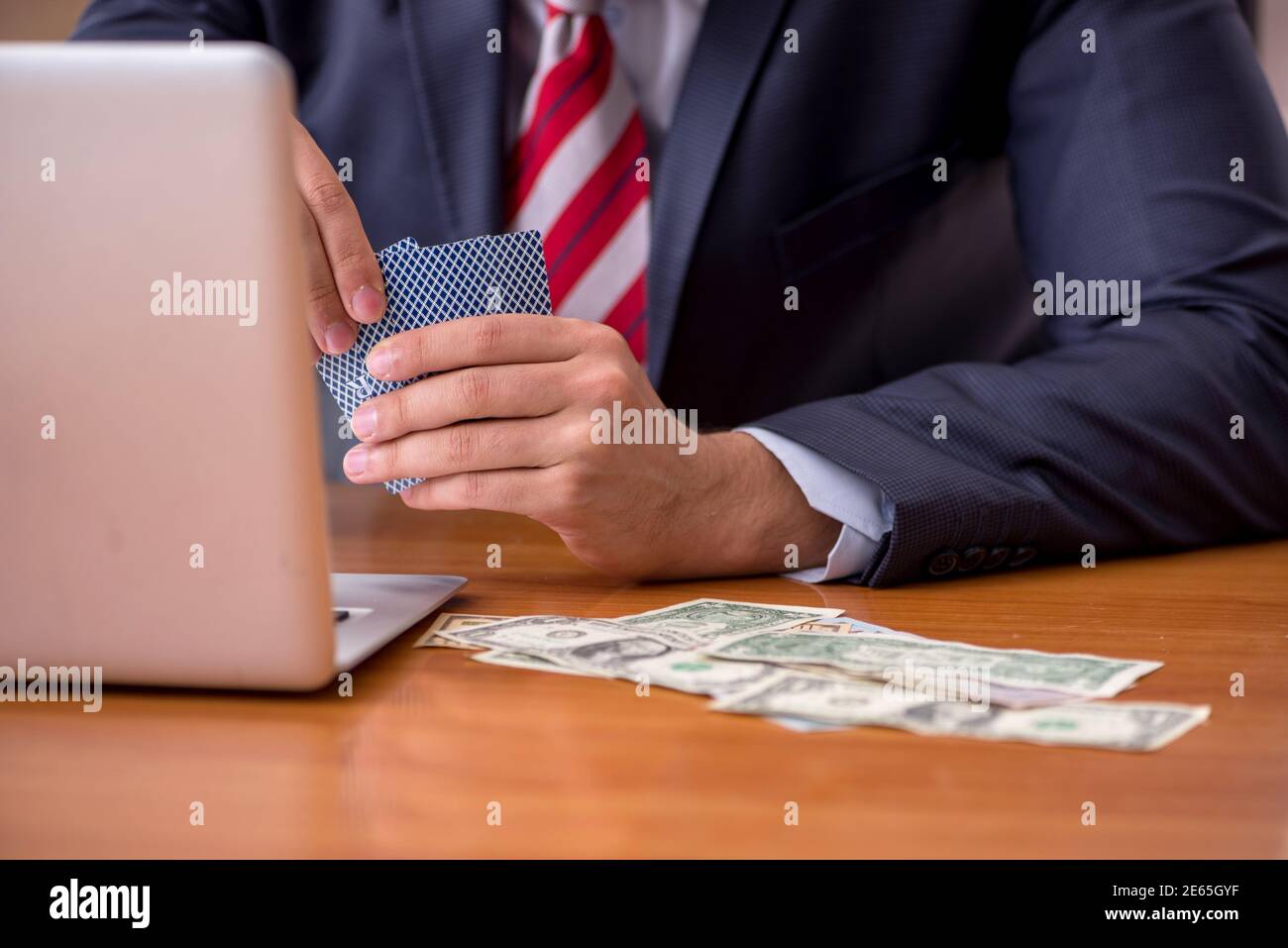 Young employee playing cards at workplace Stock Photo - Alamy