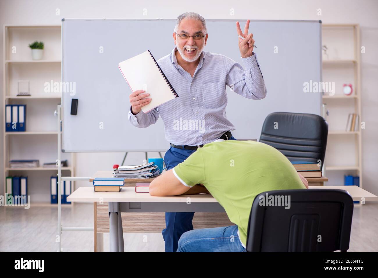 Aged male teacher and young male student in the classroom Stock Photo ...