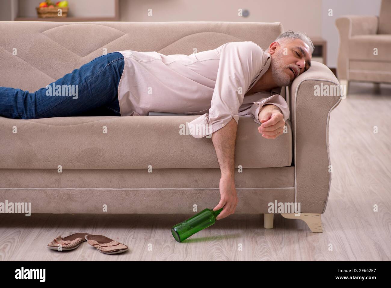Aged man drinking alcohol at home Stock Photo - Alamy