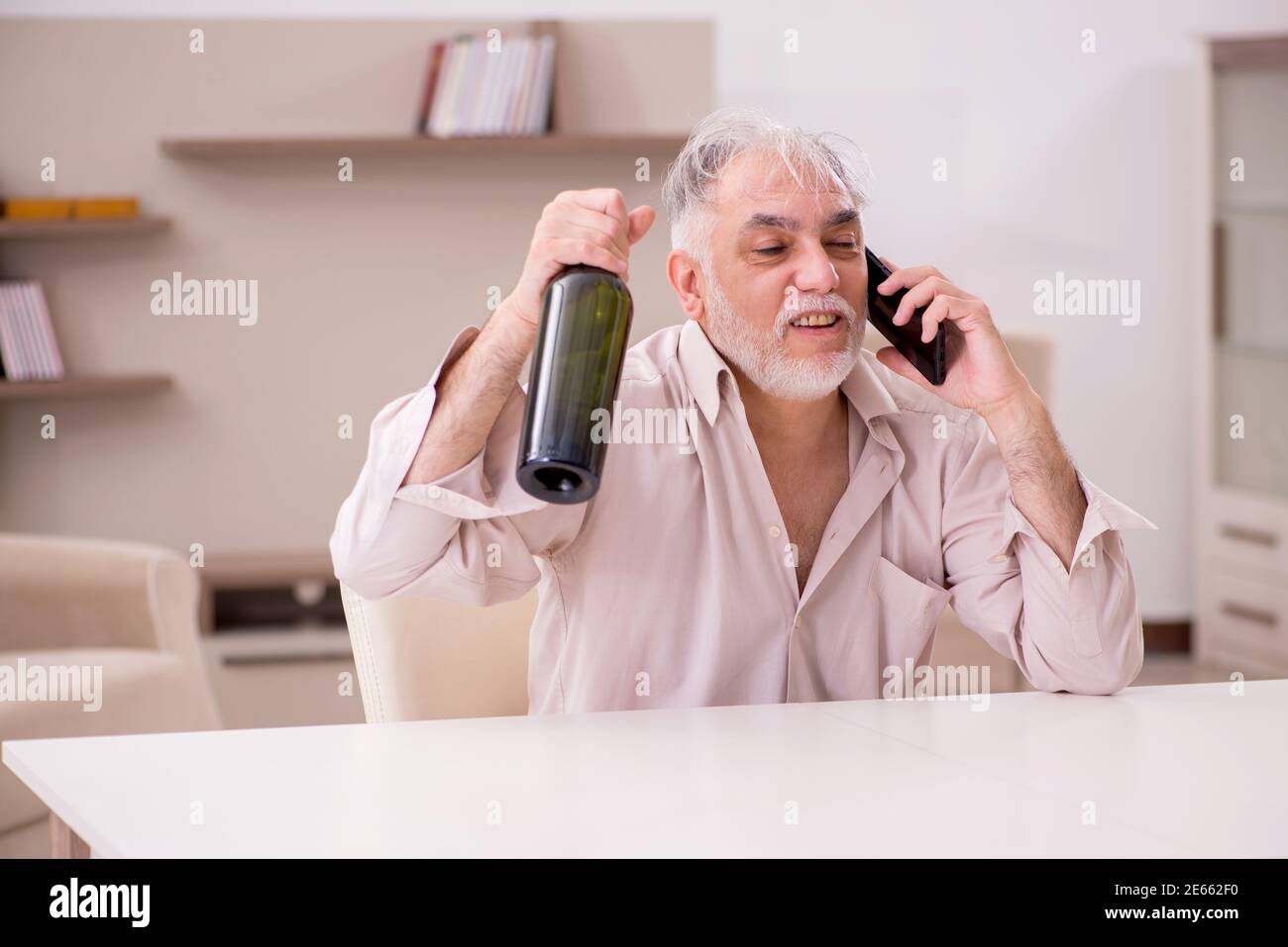 Aged man drinking alcohol at home Stock Photo - Alamy