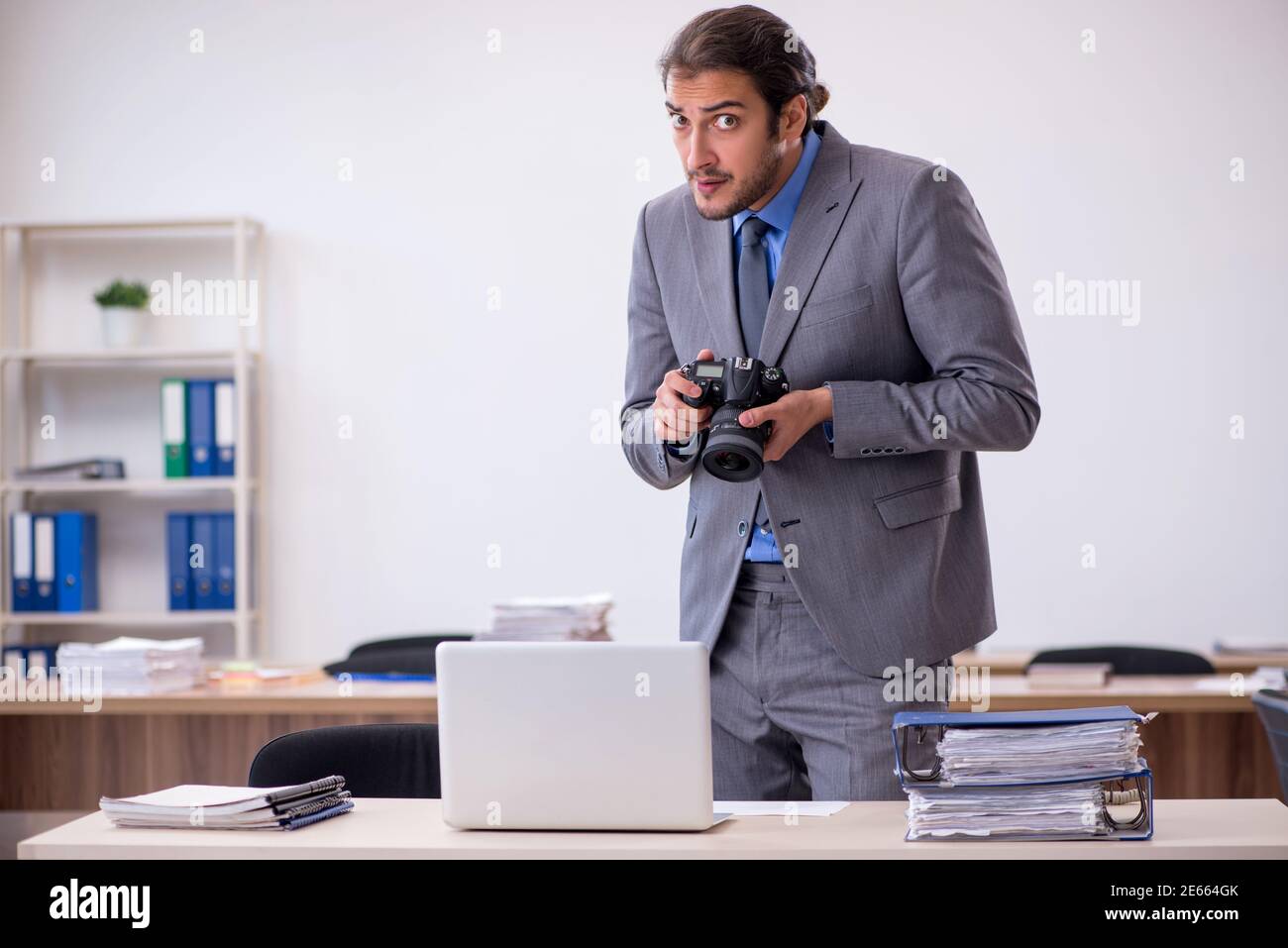 Young employee in industrial espionage concept Stock Photo - Alamy