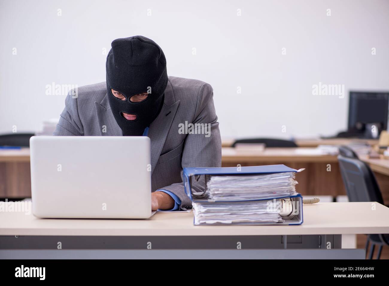 Young employee in industrial espionage concept Stock Photo - Alamy