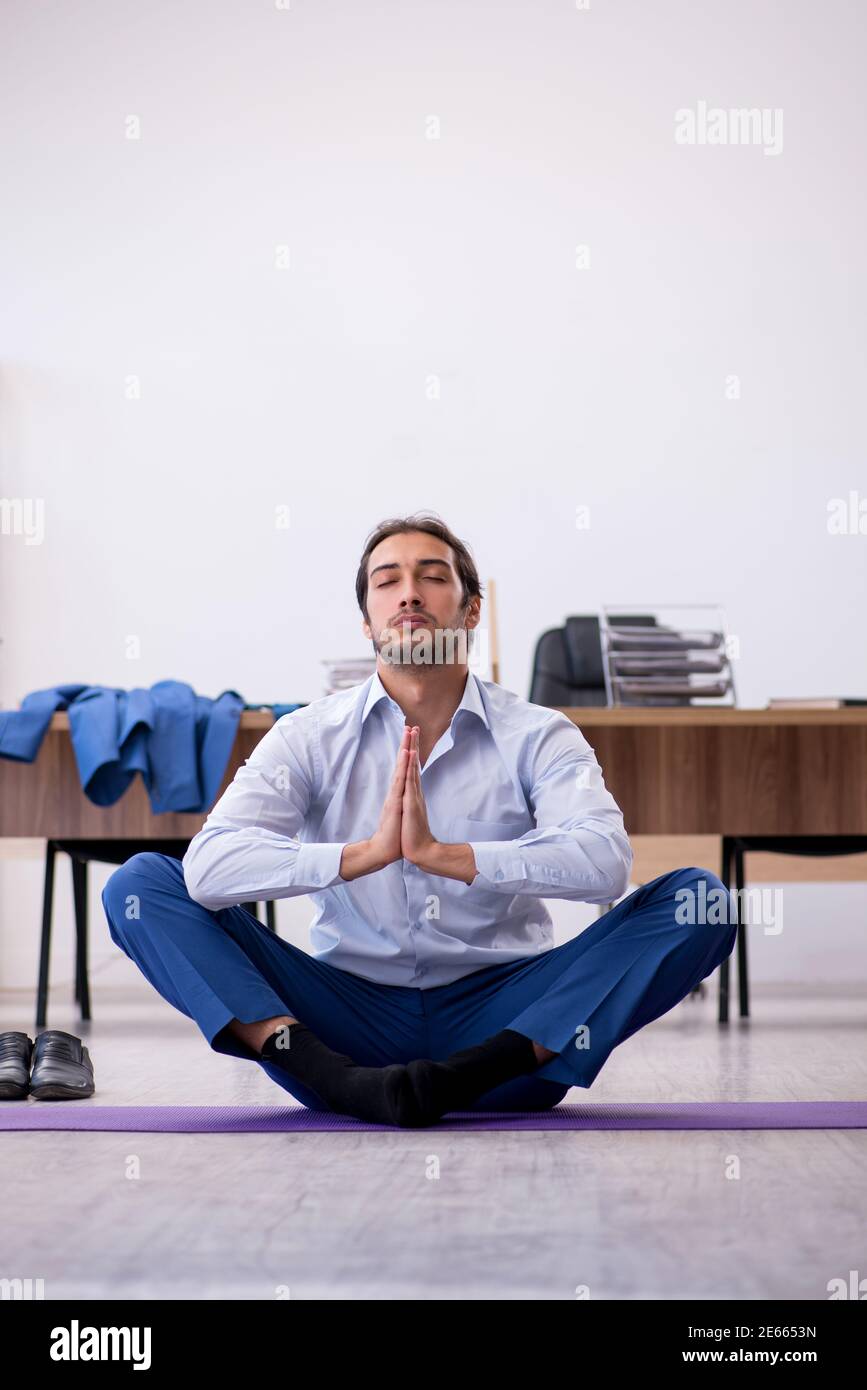 Young employee doing sport exercises during break Stock Photo - Alamy