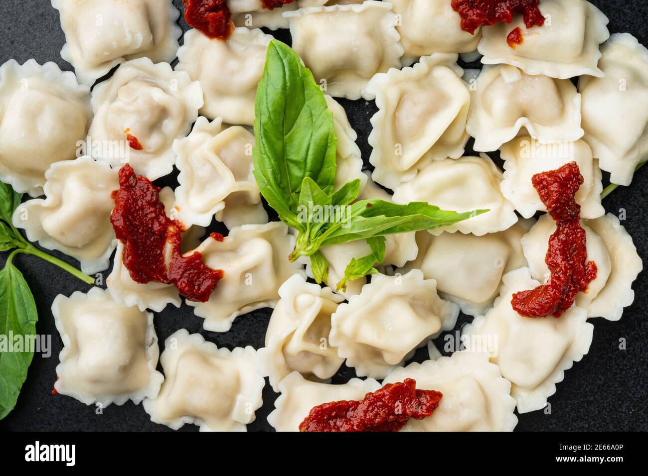 Appetizing ravioli with tomato sauce, cheese and basil set with basil ...