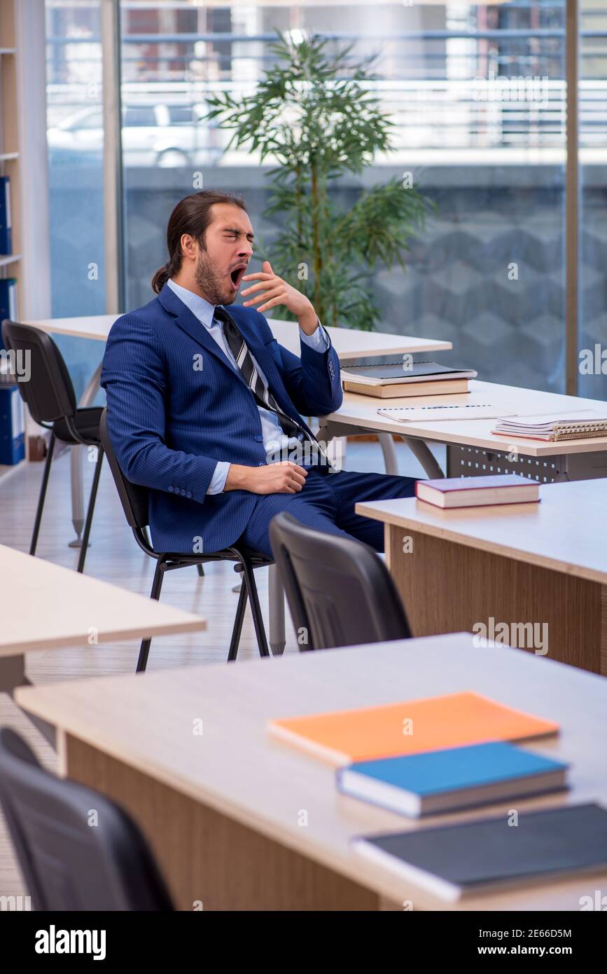Young teacher in suit in the classroom Stock Photo - Alamy