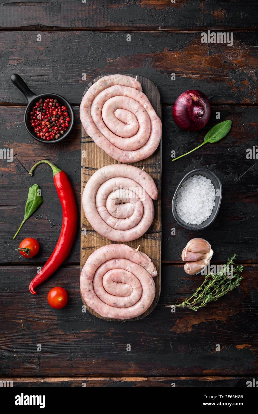 Raw snail sausage in traditional spiral set, on old dark wooden table ...