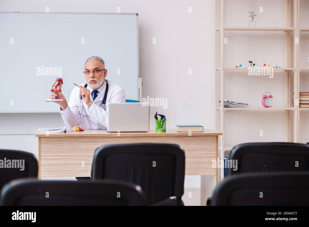 Old doctor lecturer in the classroom during pandemic Stock Photo - Alamy