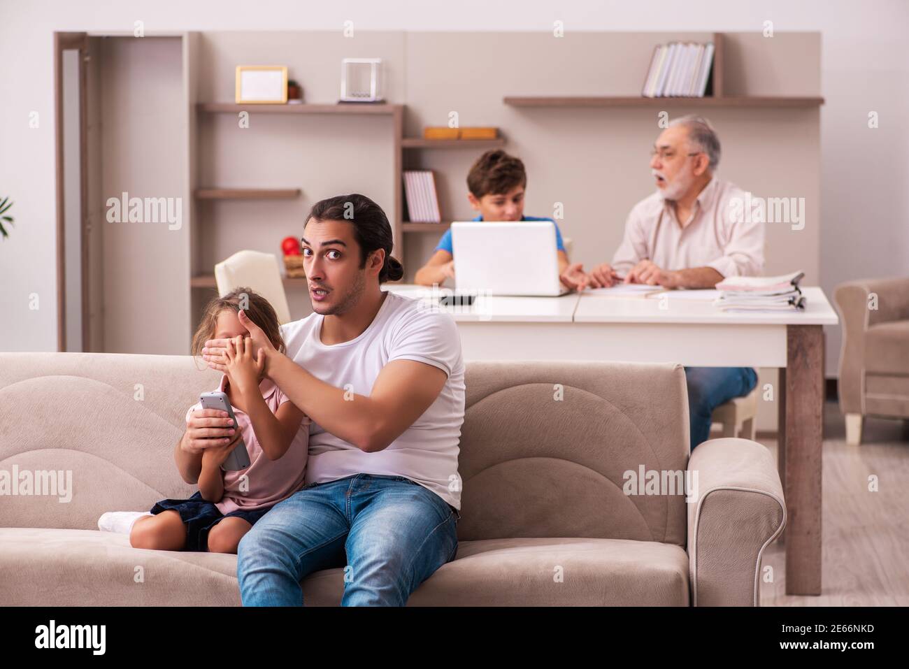 Three generations family watching tv hi-res stock photography and ...