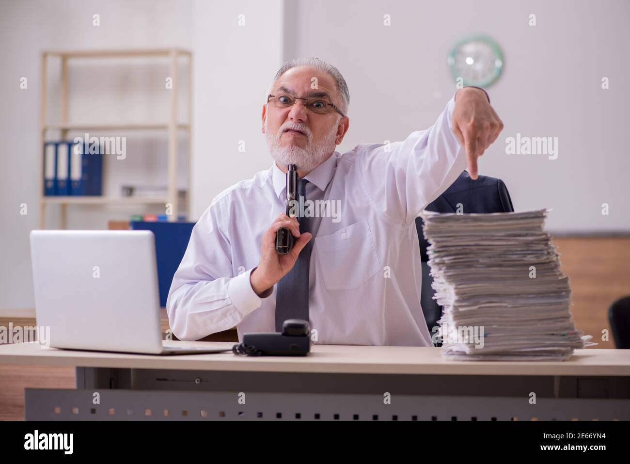 Old employee being desperate with excessive work in the office Stock ...