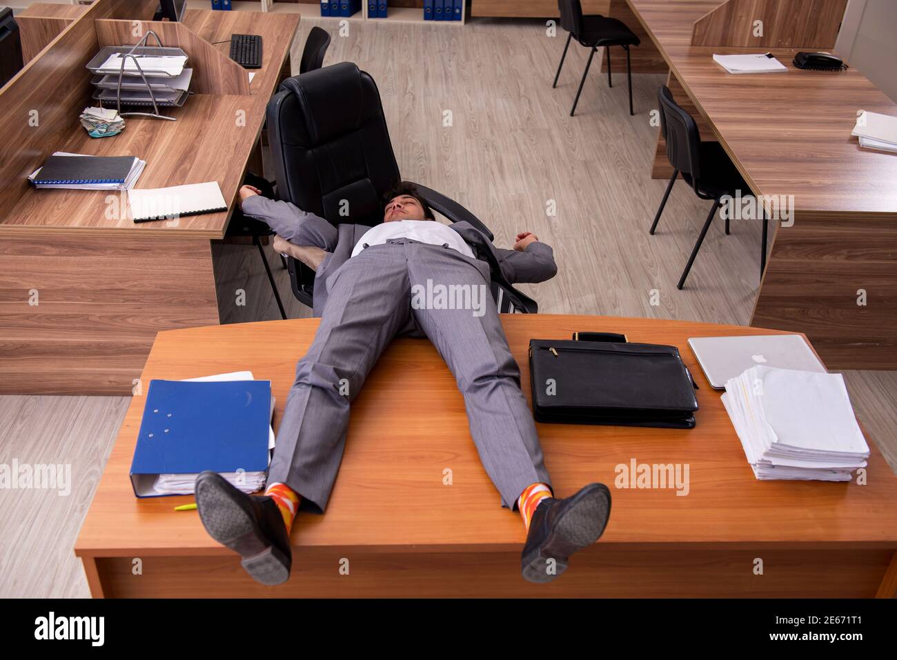 Young employee sleeping at workplace Stock Photo - Alamy