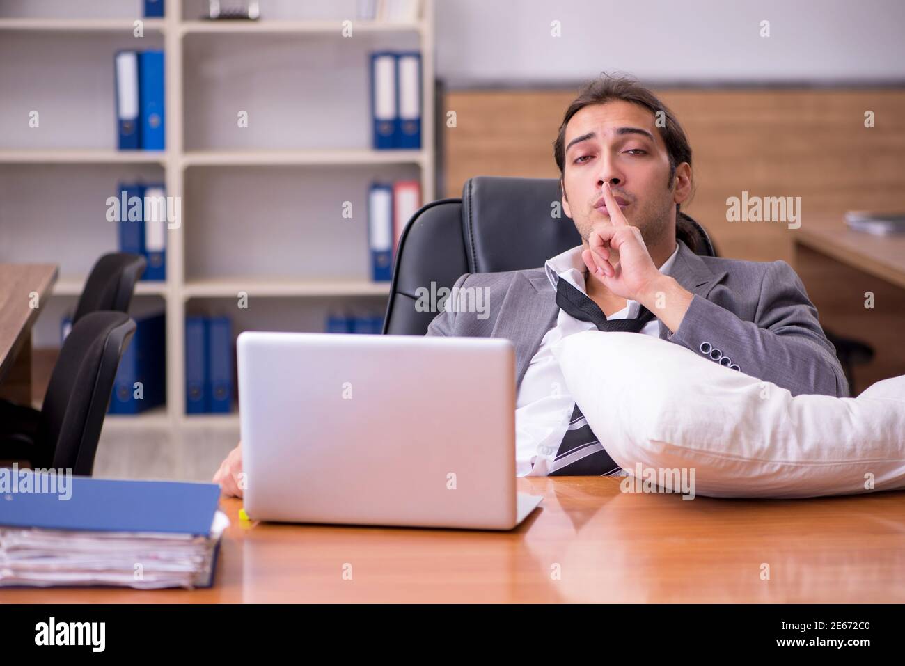 Young employee sleeping at workplace Stock Photo - Alamy