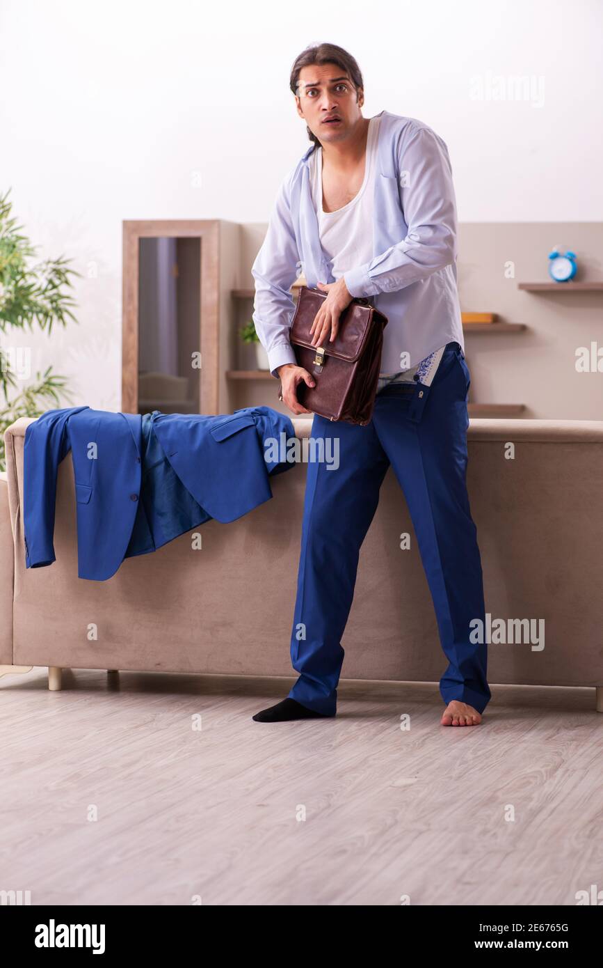 Young employee getting up late at home Stock Photo - Alamy