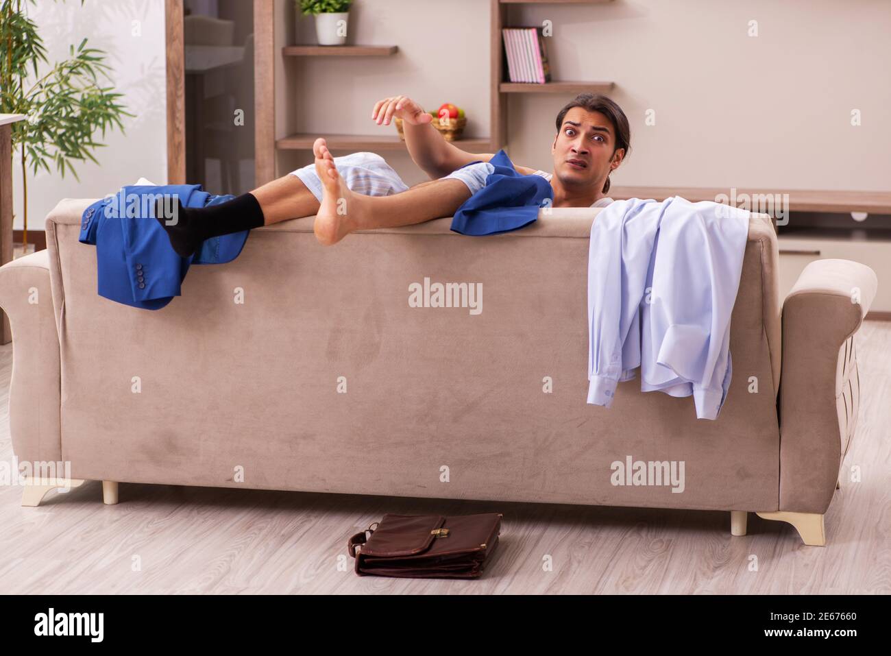 Young employee getting up late at home Stock Photo - Alamy