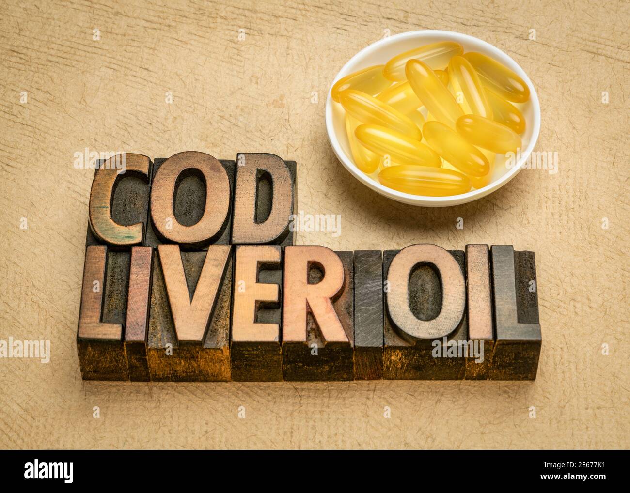 cod liver oil - dietary supplement, a bowl of capsules with vintage ...