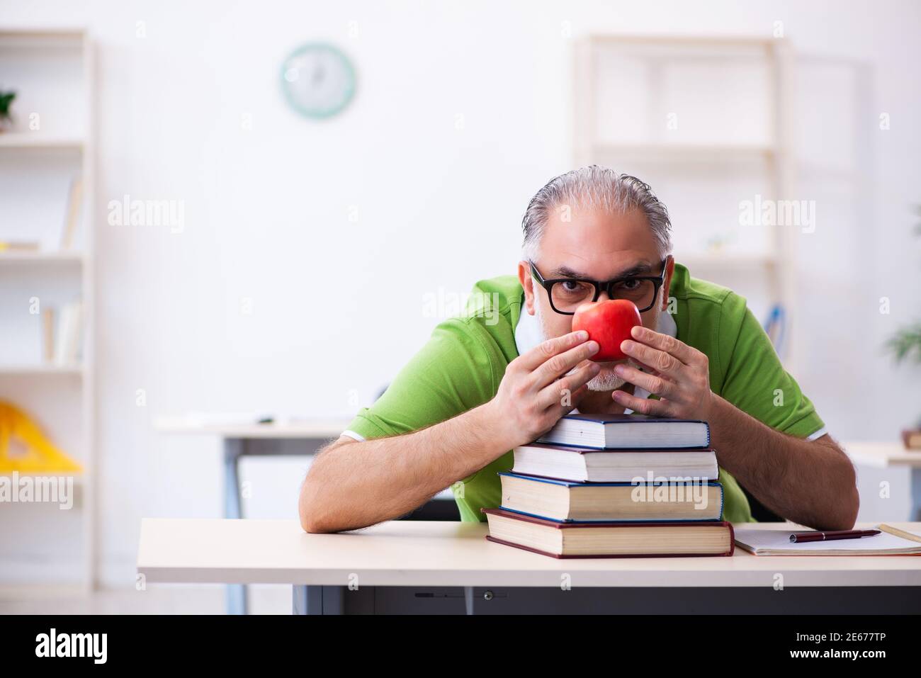 Male teacher eating apple hi-res stock photography and images - Alamy