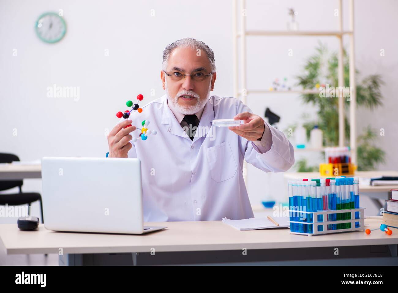 Senior male scientist studying molecular model Stock Photo - Alamy